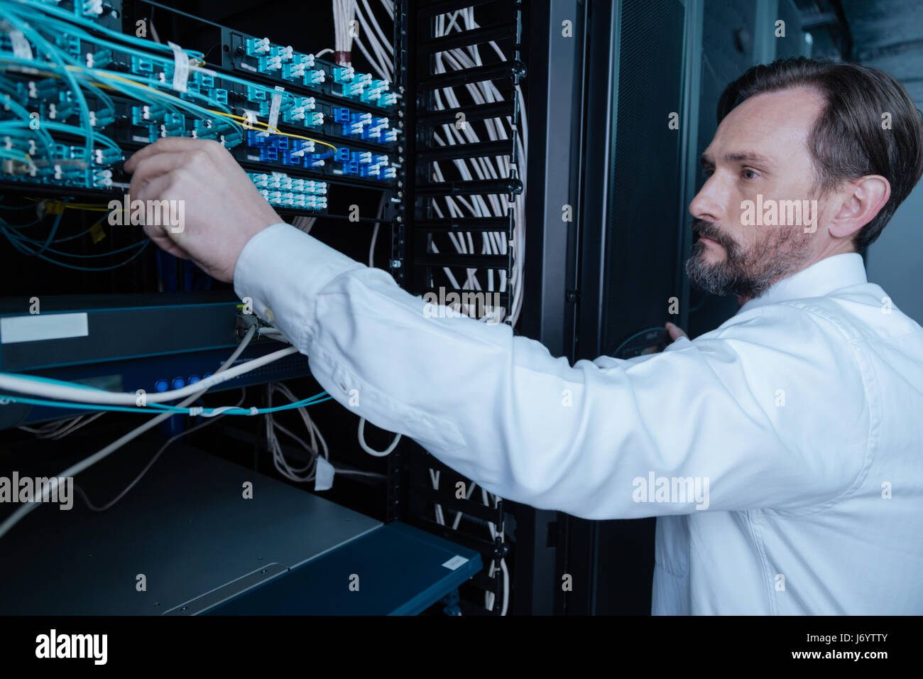 Serious bearded man looking at the internet wires Stock Photo - Alamy