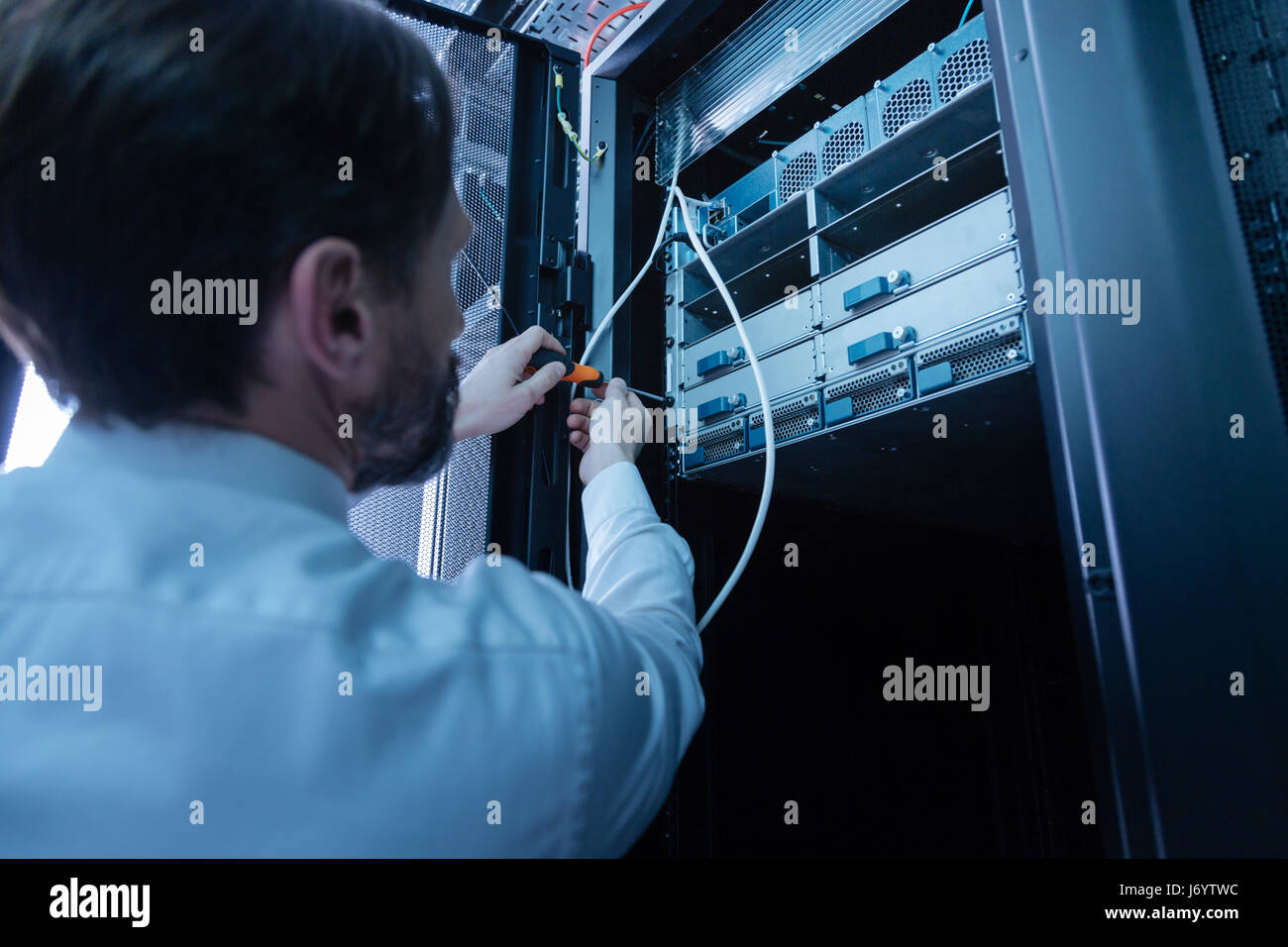 Smart professional technician fixing the network server Stock Photo - Alamy