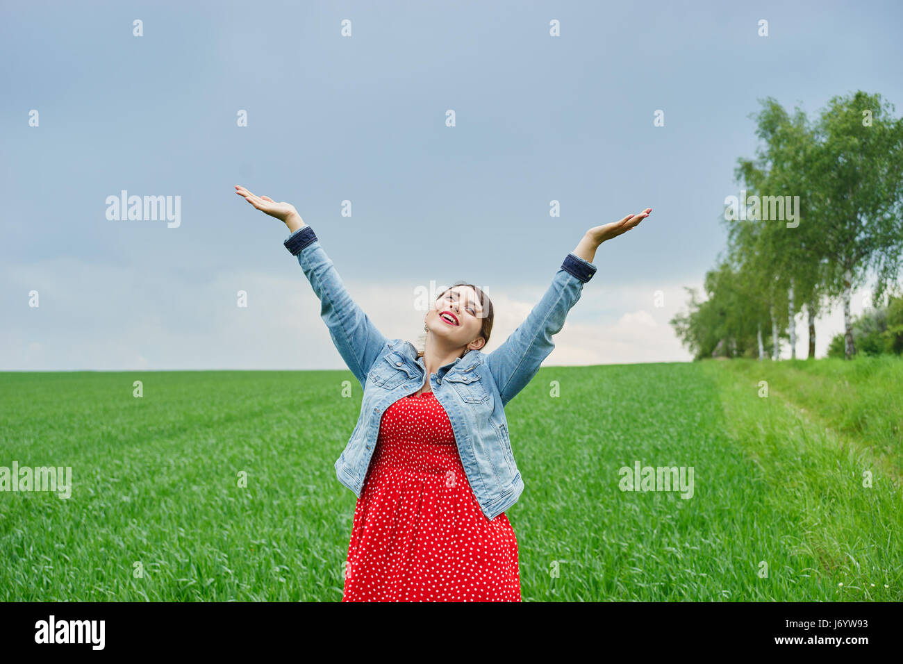 A happy woman with open arms in nature Stock Photo - Alamy