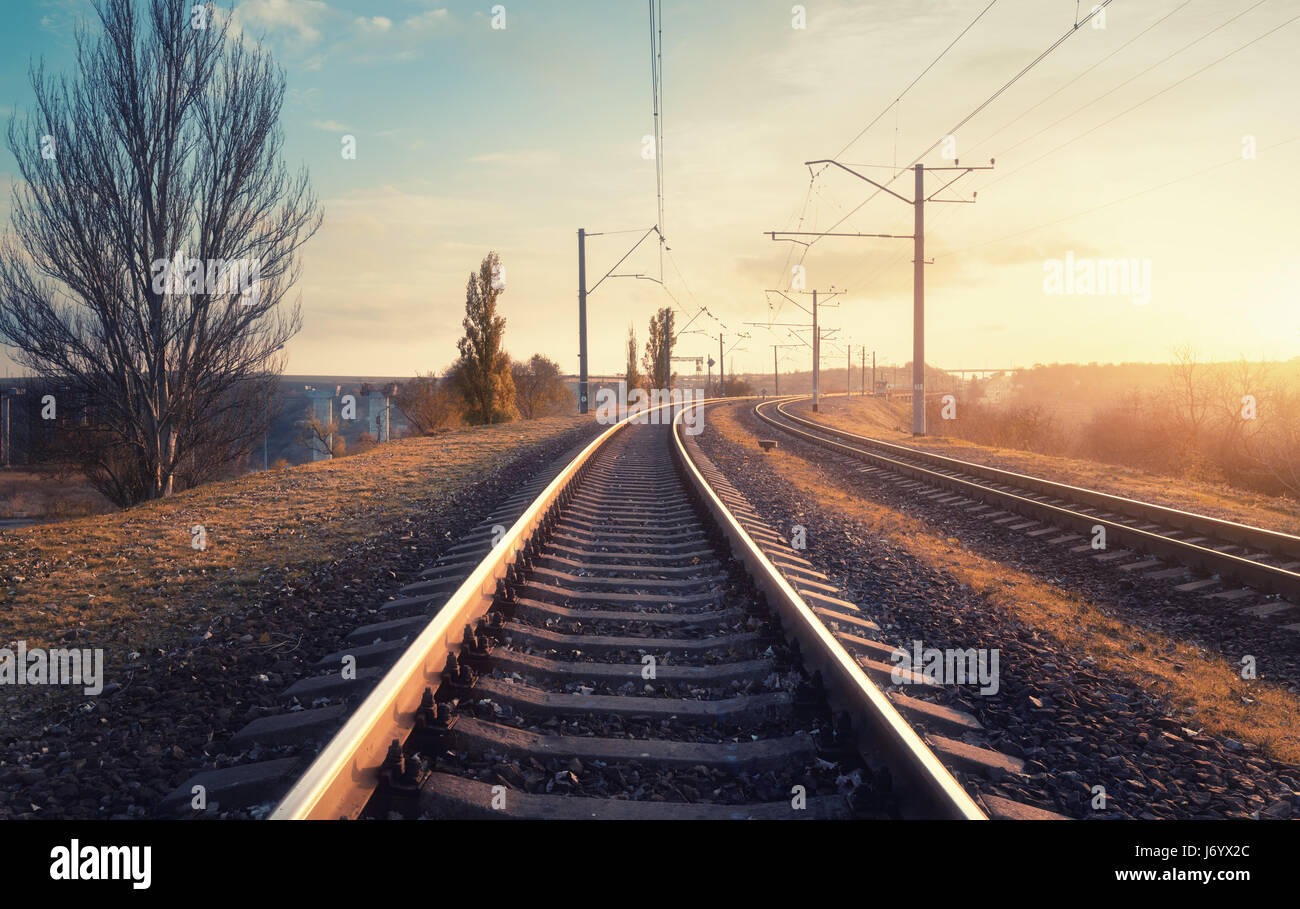 Railroad and beautiful sky at sunset. Industrial landscape with railway ...