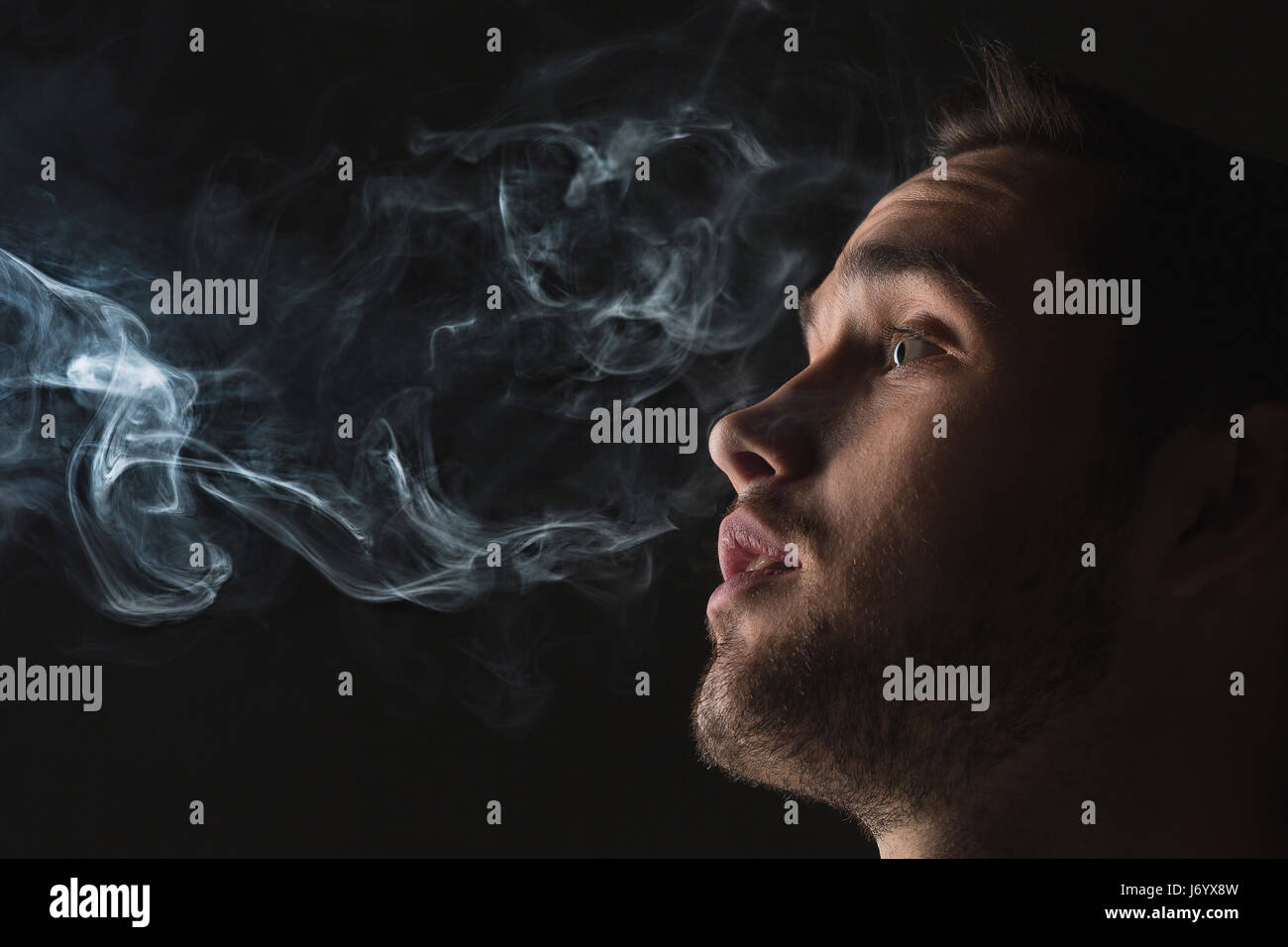 The face of vaping young man Stock Photo - Alamy