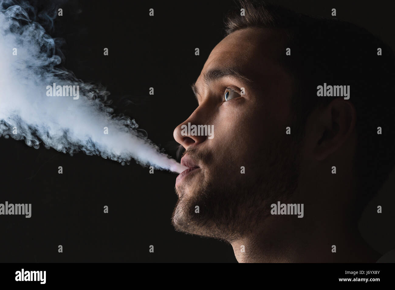 The face of vaping young man Stock Photo - Alamy