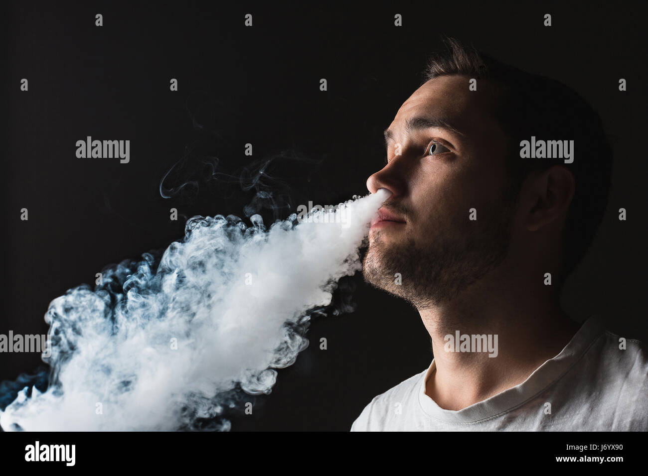 The face of vaping young man Stock Photo - Alamy