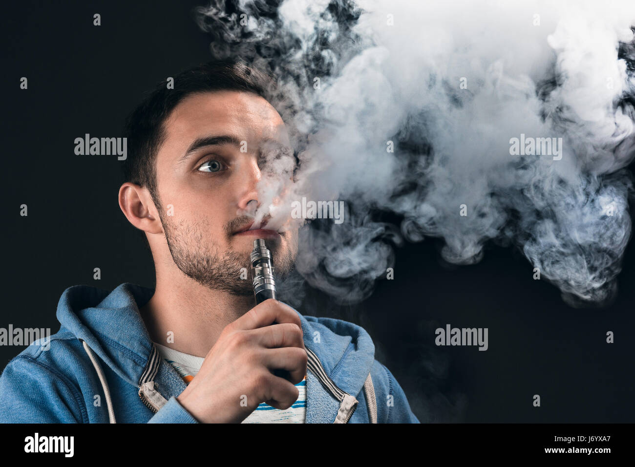 The face of vaping young man Stock Photo - Alamy