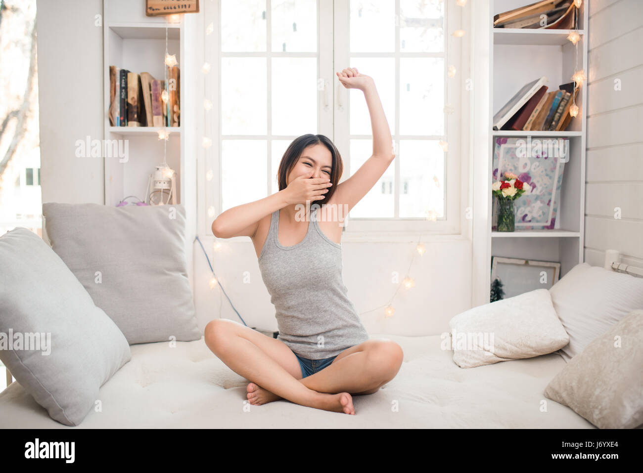 Tired sleepy asian woman waking up and stretching while sitting in bed at home Stock Photo - Alamy