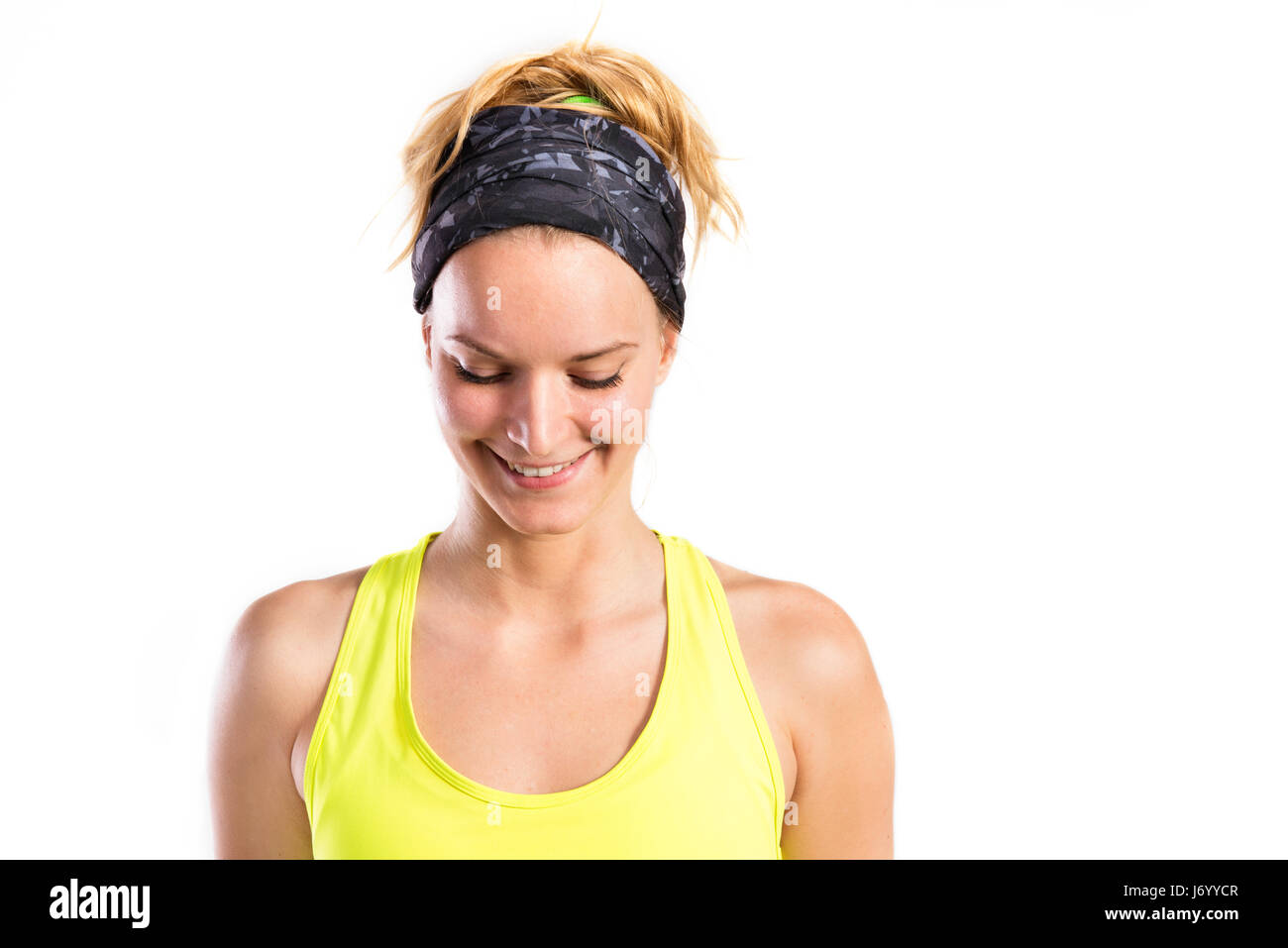 Attractive young fitness woman in yellow tank top. Studio shot Stock ...