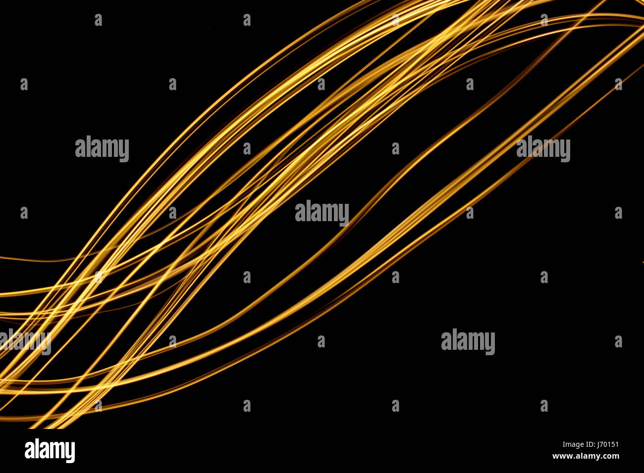 Long exposure photograph of neon gold colour in an abstract wavy ...