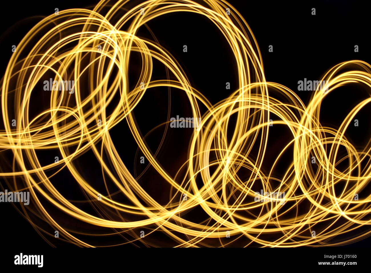 Long exposure photograph of neon gold colour in an abstract wavy ...