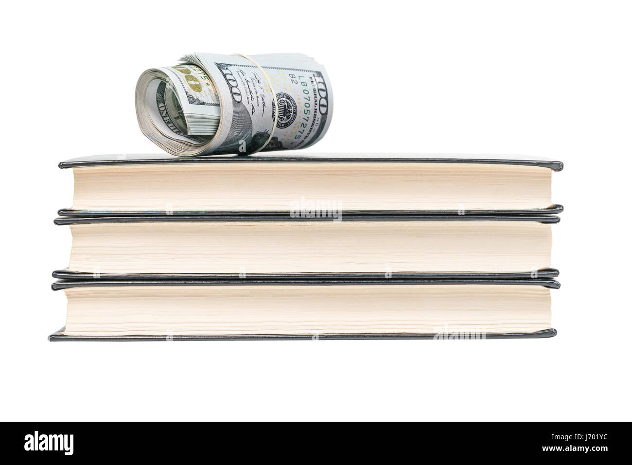 Dollars on a pile of books Stock Photo - Alamy