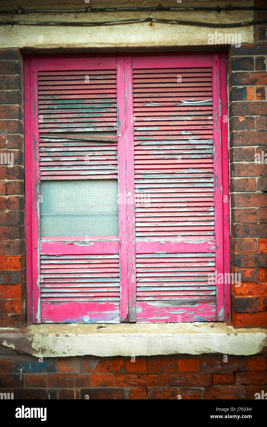 Faded and peeling red paint on shuttered window Stock Photo - Alamy