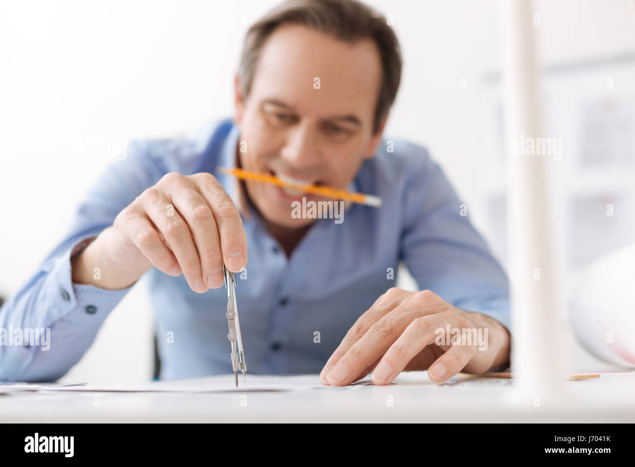 Professional involved engineer drawing a blueprint Stock Photo - Alamy
