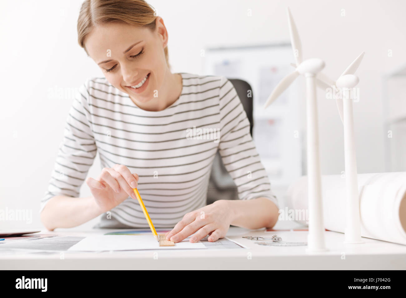 Cheerful professional engineer making a drawing Stock Photo - Alamy