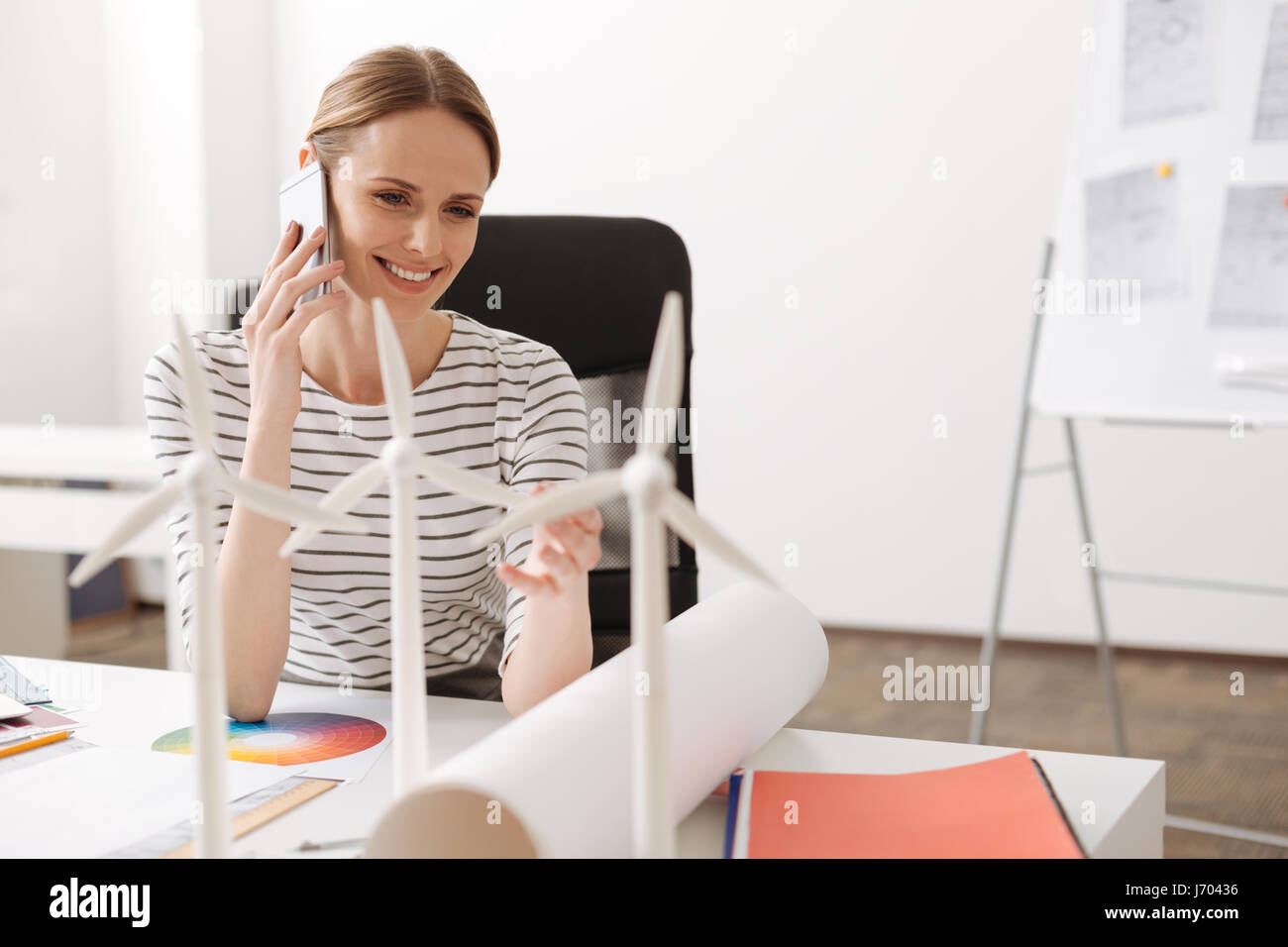 Delighted professional woman sitting in the office Stock Photo - Alamy