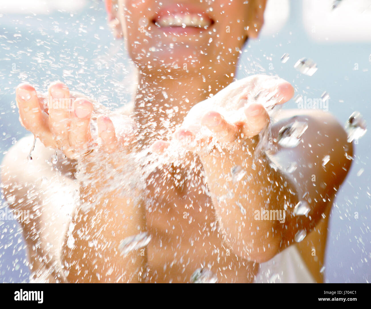 Young woman and water splash Stock Photo - Alamy