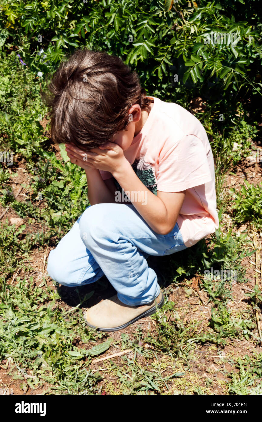 Boy crying in the park Stock Photo - Alamy
