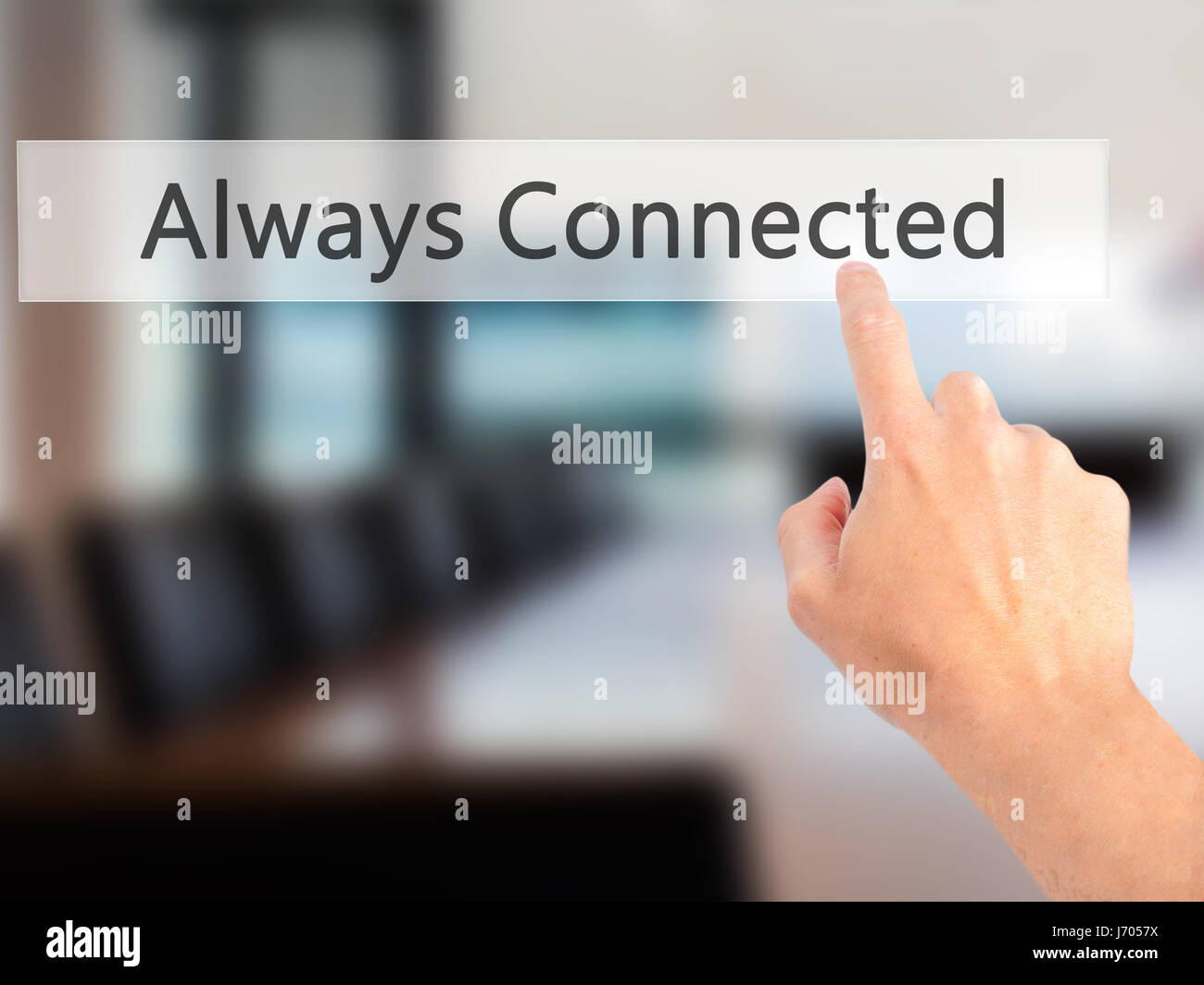Always Connected- Hand pressing a button on blurred background concept ...