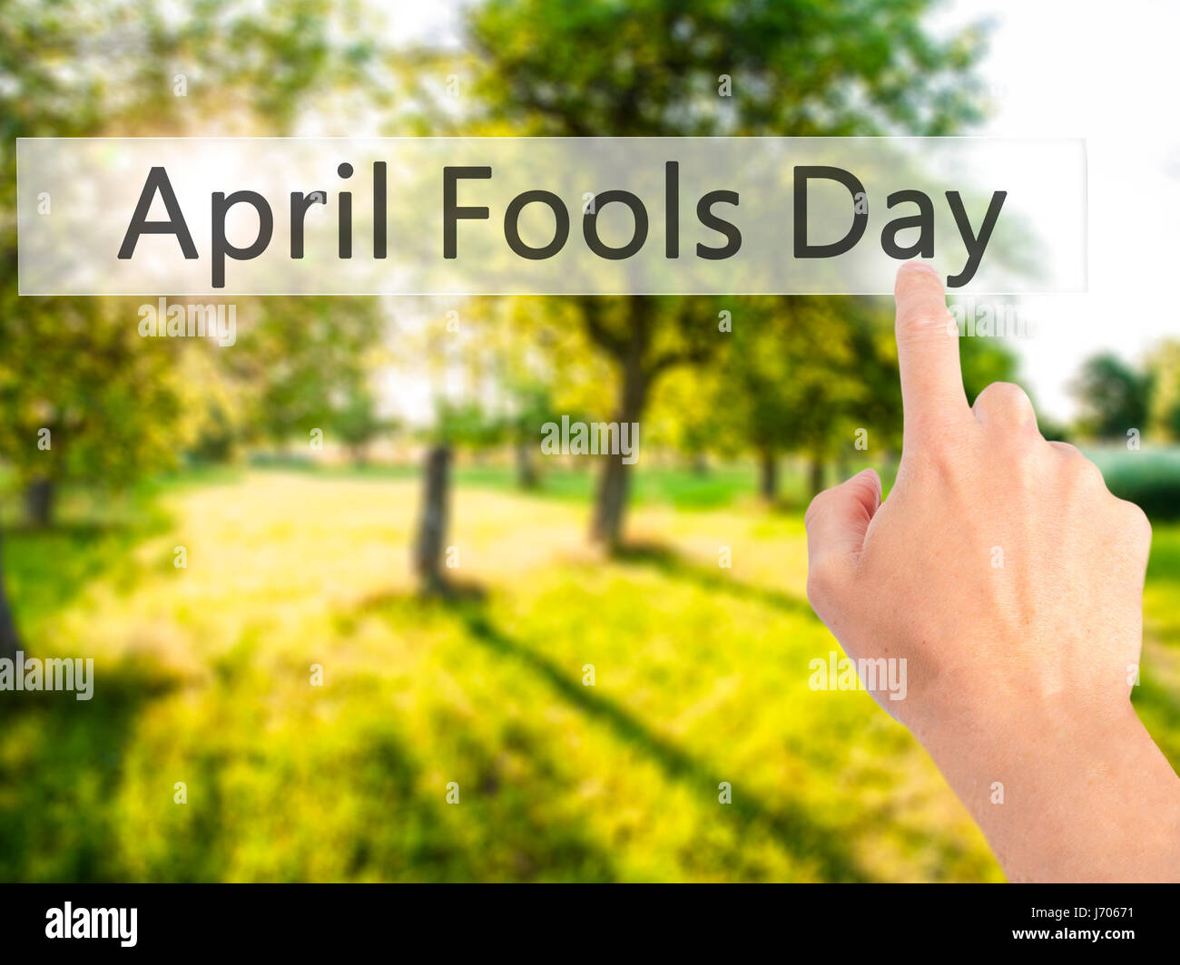 April Fools Day - Hand pressing a button on blurred background concept ...