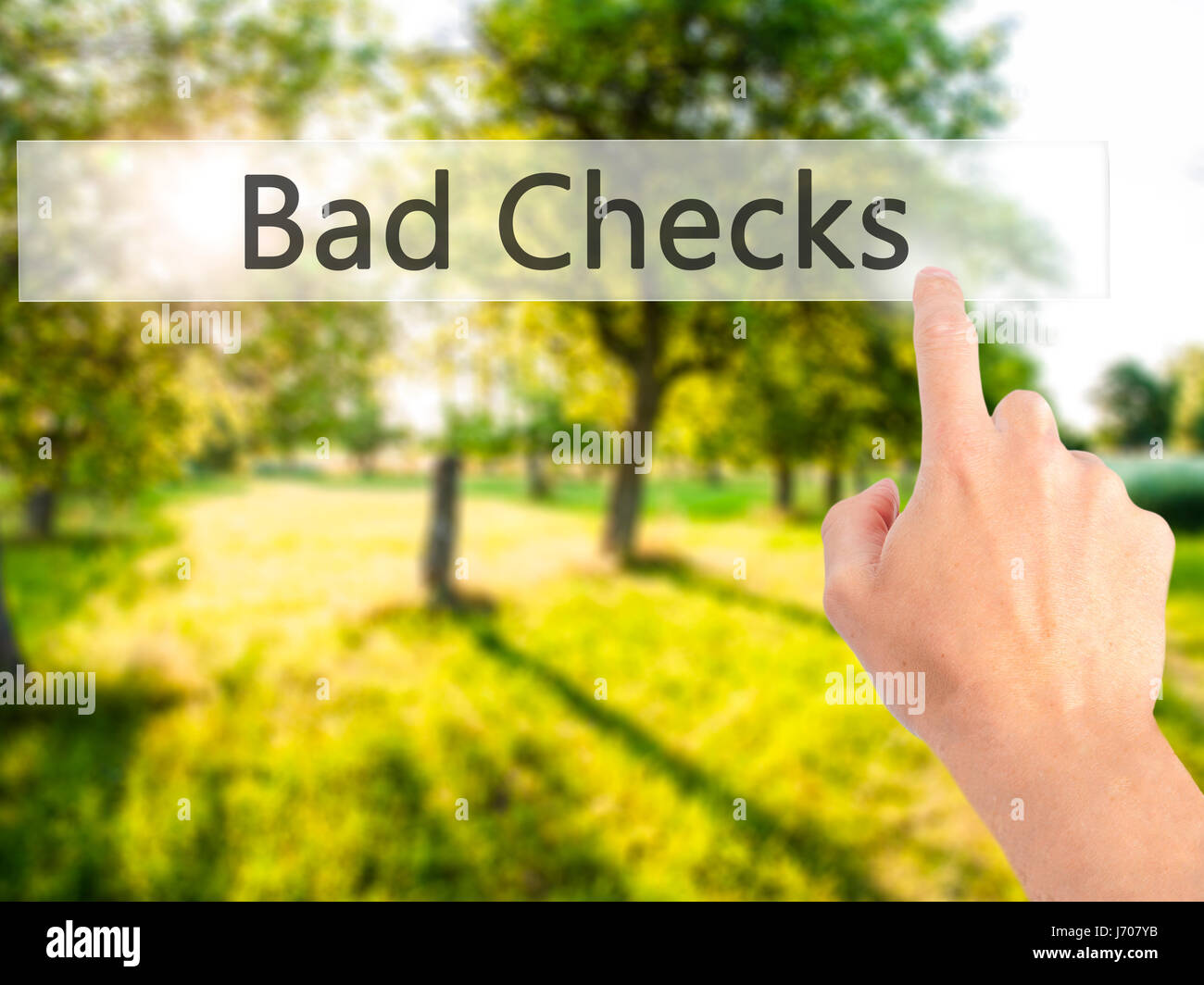 Bad Checks - Hand pressing a button on blurred background concept ...
