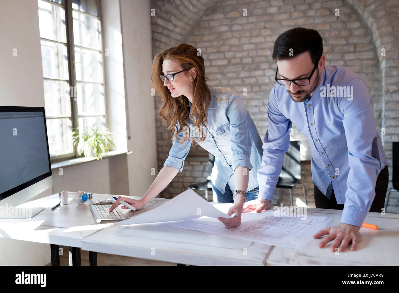 Coworking process, designers team working in modern office Stock Photo ...