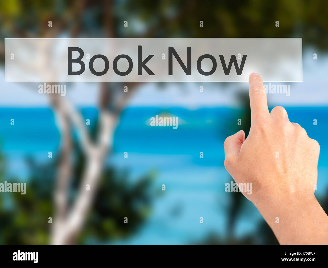 Book Now - Hand pressing a button on blurred background concept ...