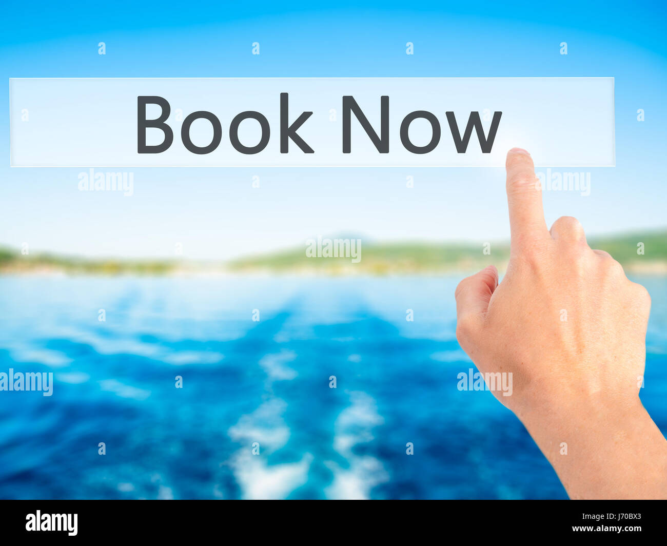 Book Now - Hand pressing a button on blurred background concept ...