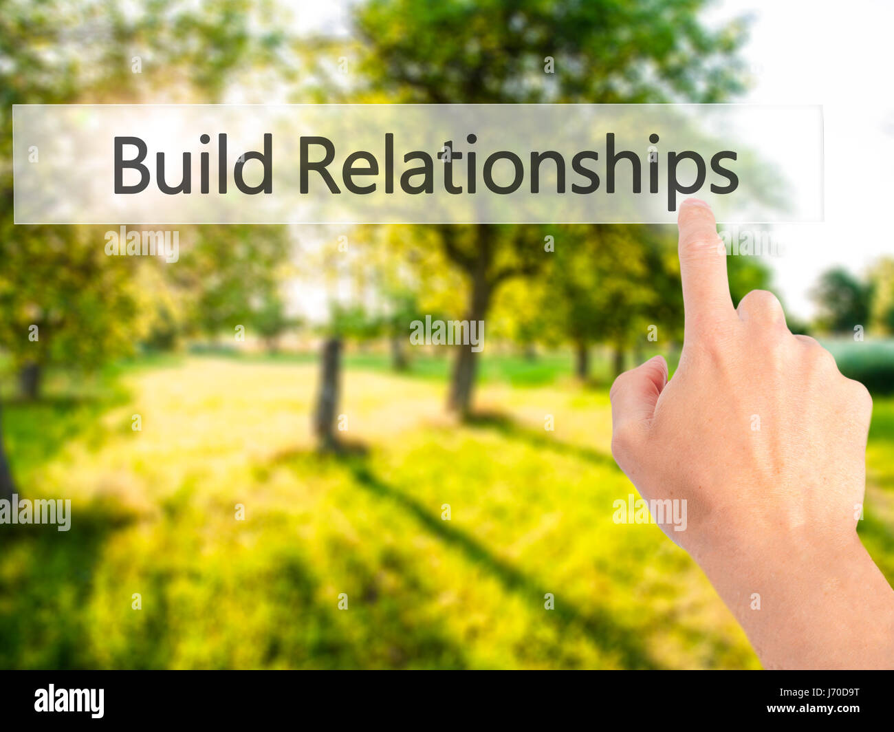 Build Relationships - Hand pressing a button on blurred background ...