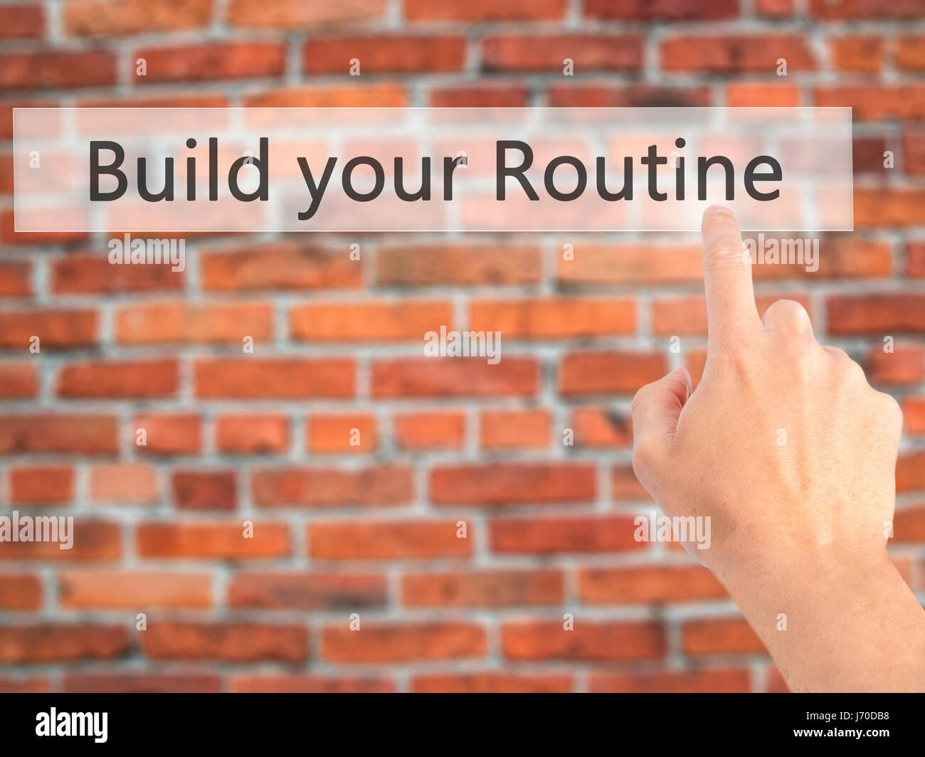 Build your Routine - Hand pressing a button on blurred background concept . Business, technology ...