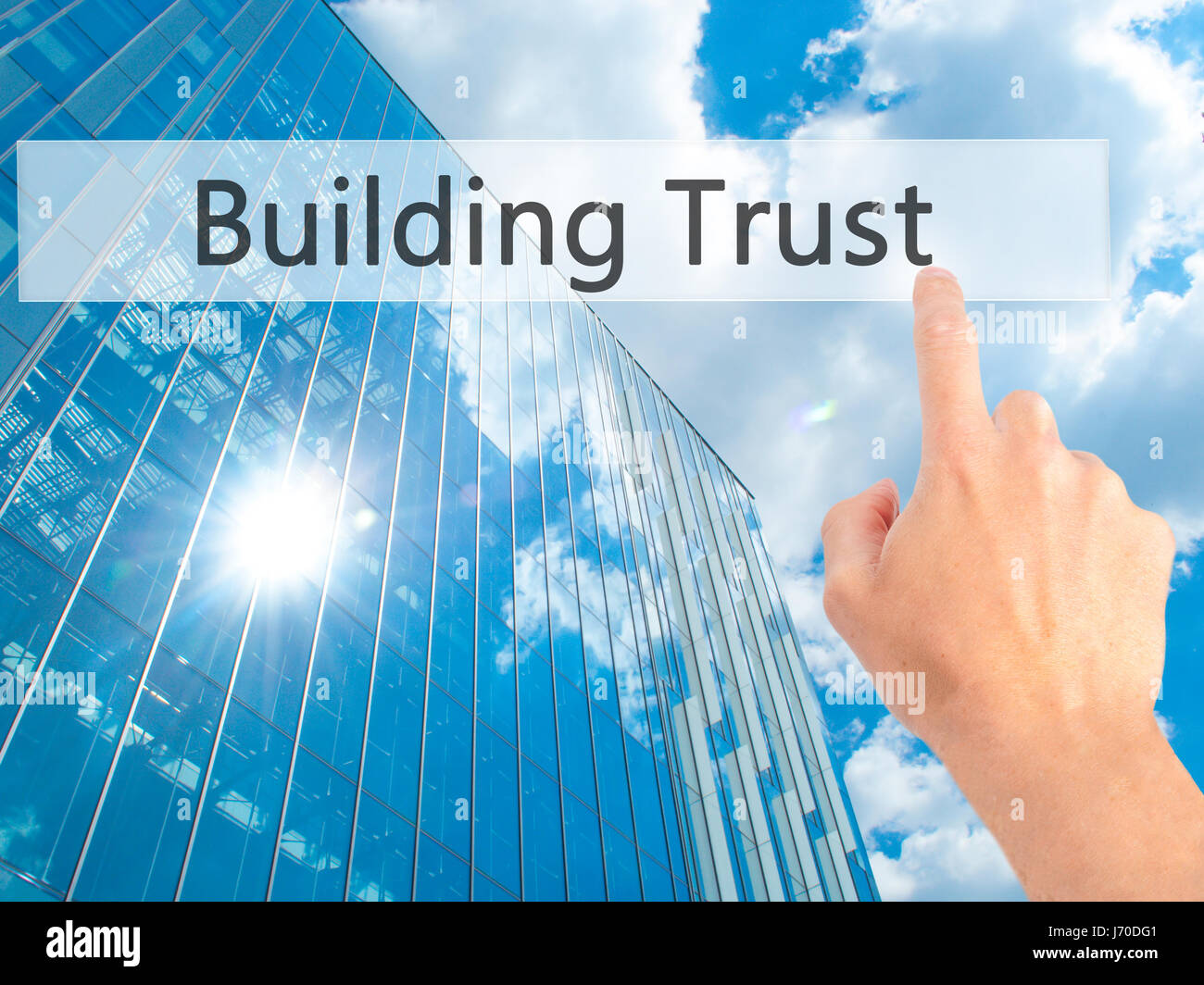 Building Trust - Hand pressing a button on blurred background concept ...