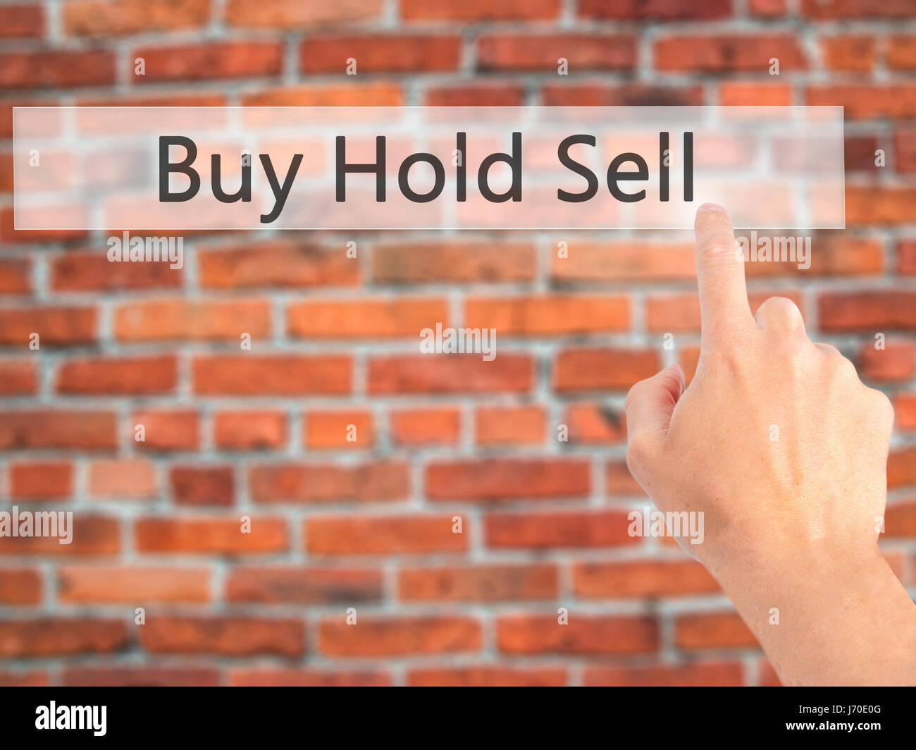 Buy Hold Sell - Hand pressing a button on blurred background concept ...
