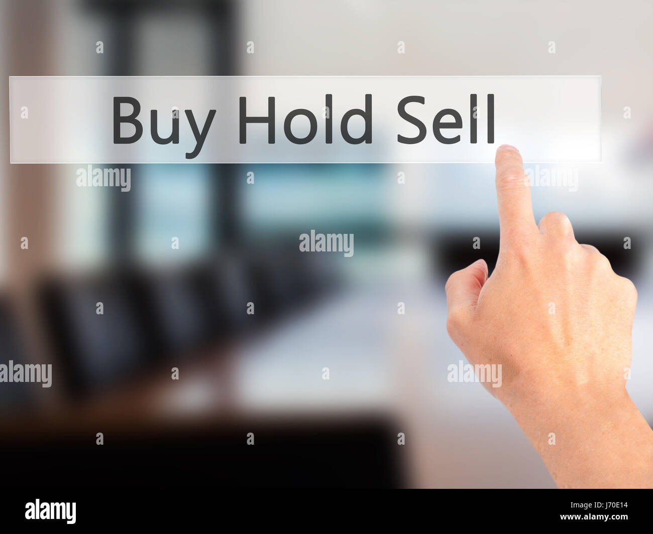 Buy Hold Sell - Hand pressing a button on blurred background concept ...