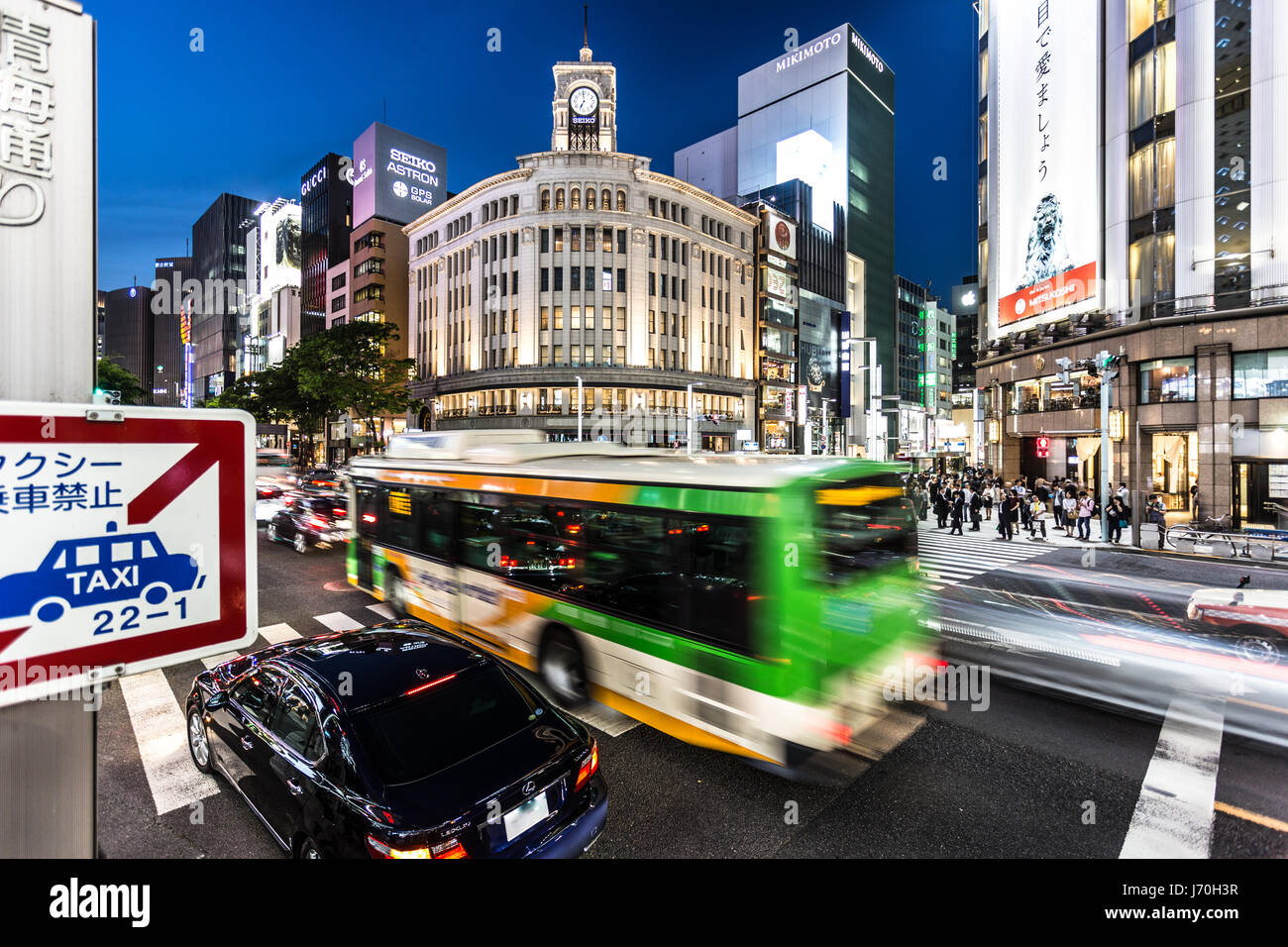 TOKYO - MAY 8, 2017: A bus rushes through an intersection in Ginza, the ...
