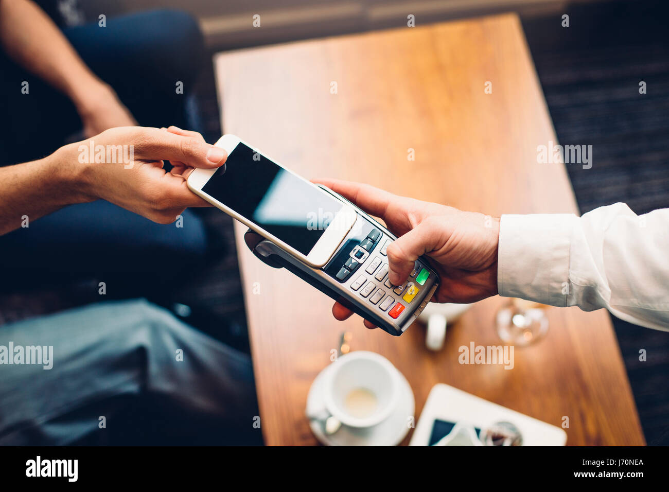 Business man making a contactless smartphone payment Stock Photo - Alamy