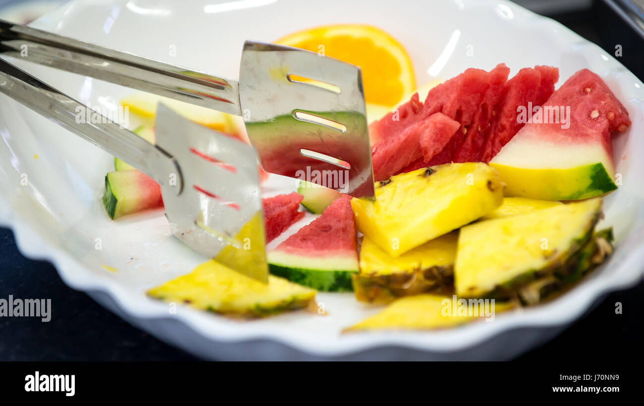 Fruit is cut up and presented on a plate for school dinners Stock Photo ...
