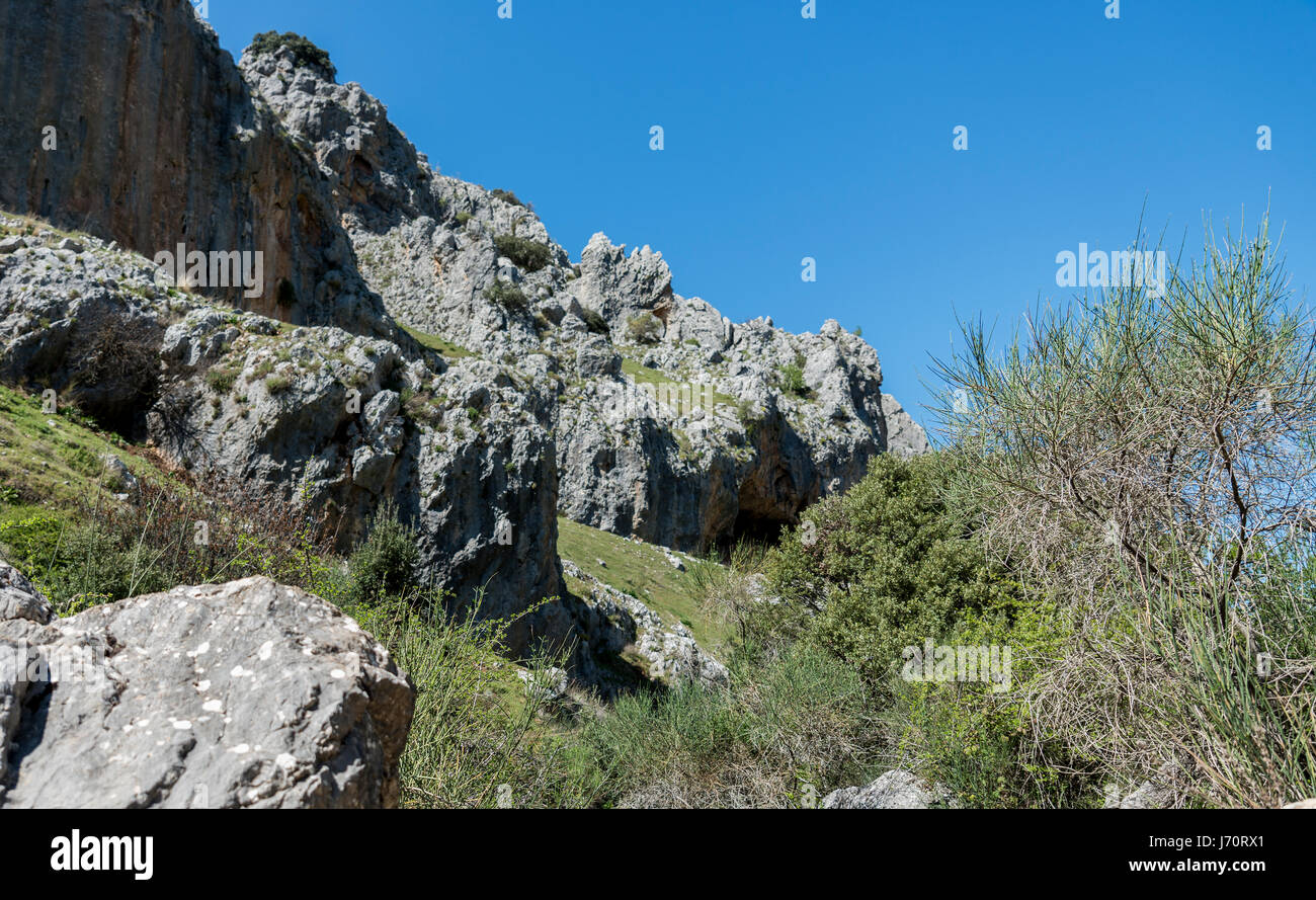 rocks with old ancient caves where people used to live and blue sky in ...