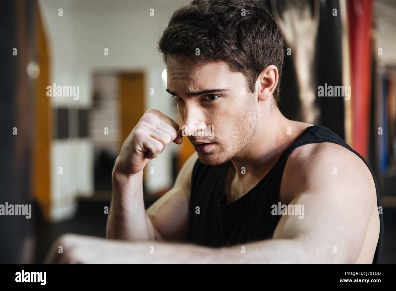 Portrair of boxer trying to kick with his hand in gym Stock Photo - Alamy