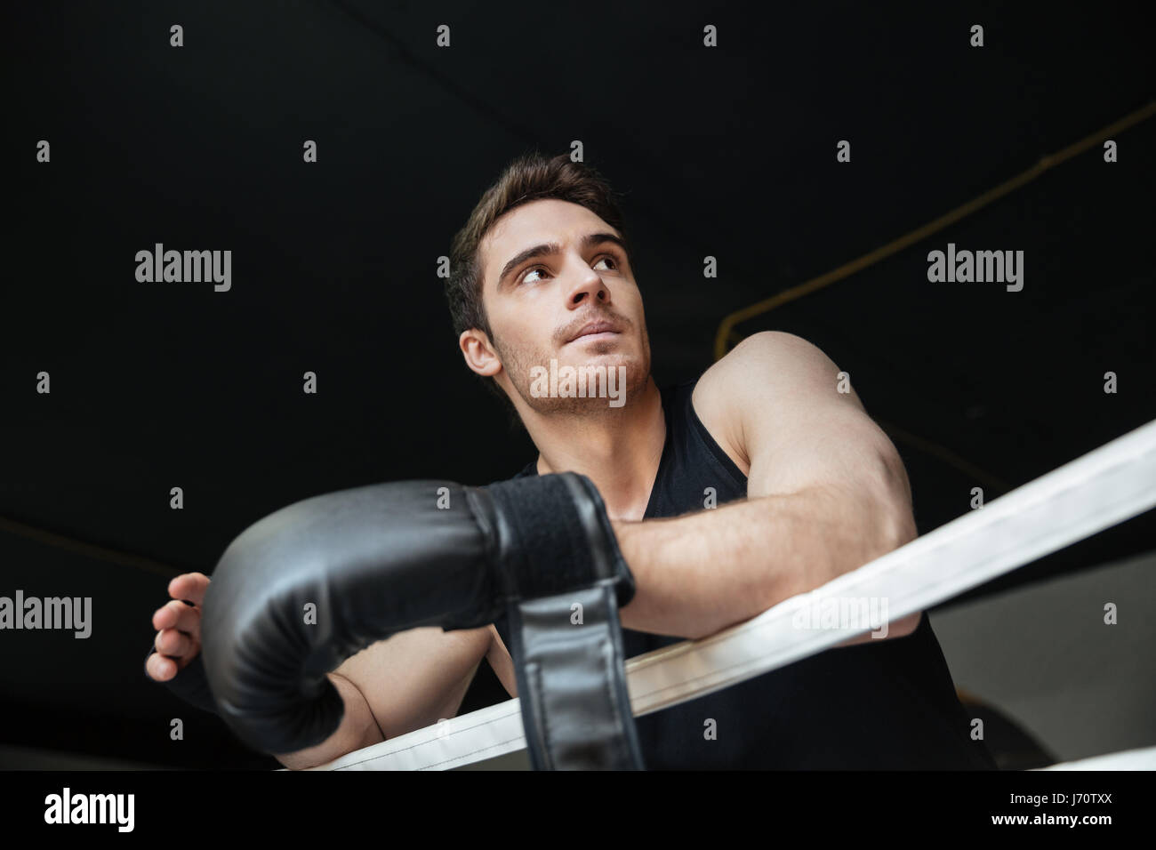 Low view of thoughtful sportsman standing on boxing ring Stock Photo ...