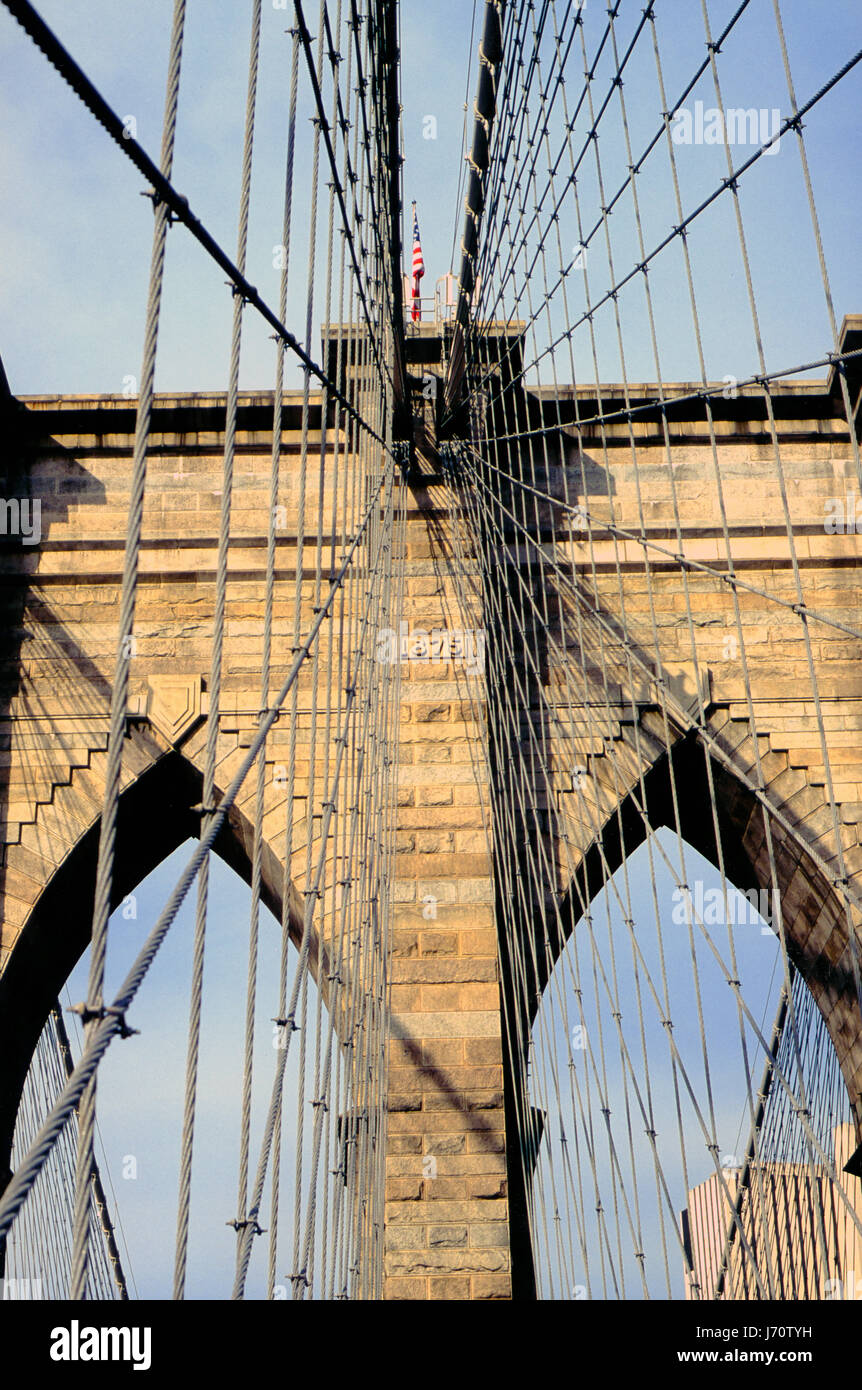 Maze of cables and a tower of the iconic Brooklyn Bridge in New York ...
