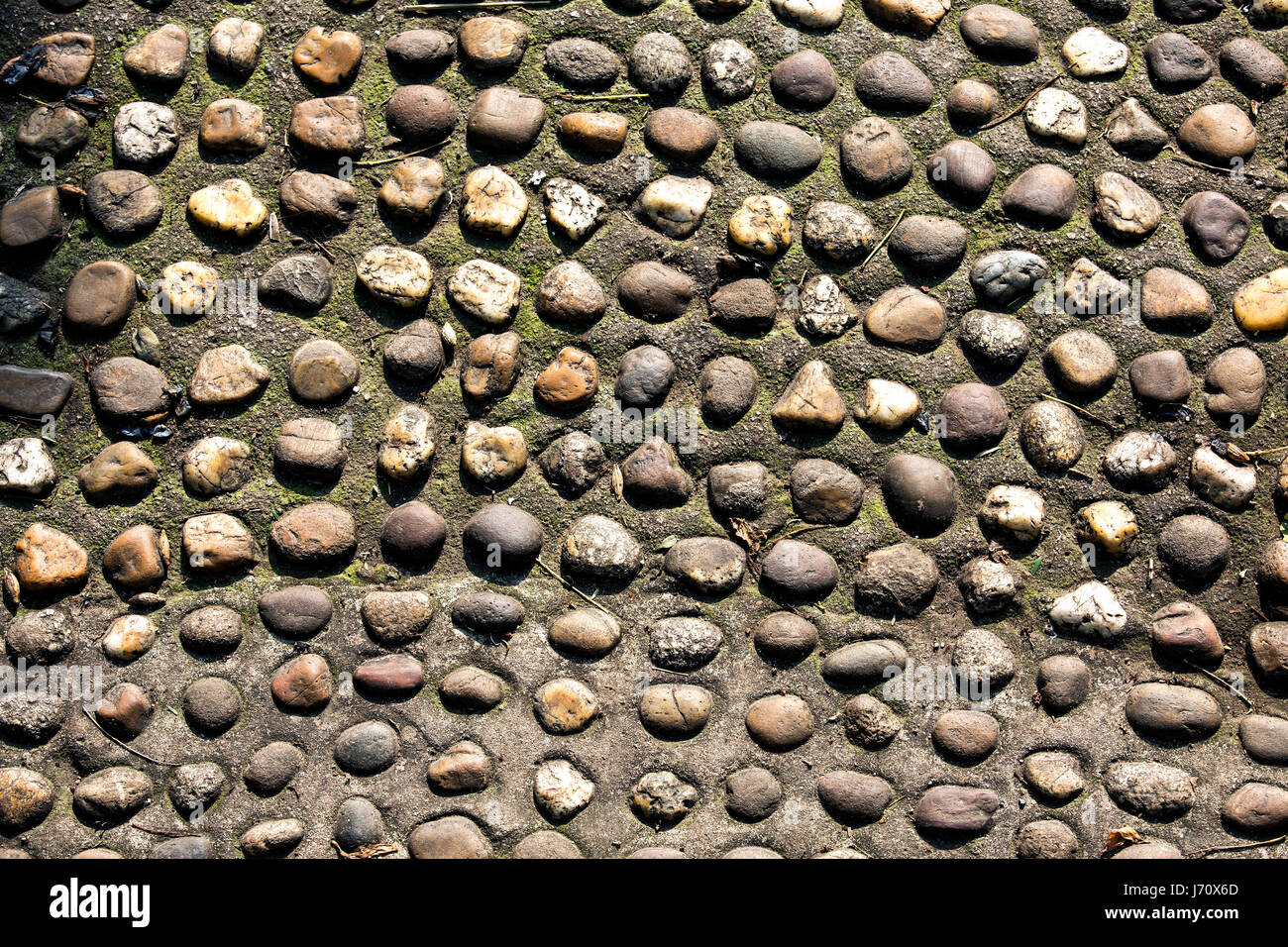 Pebbles and concrete Stock Photo - Alamy