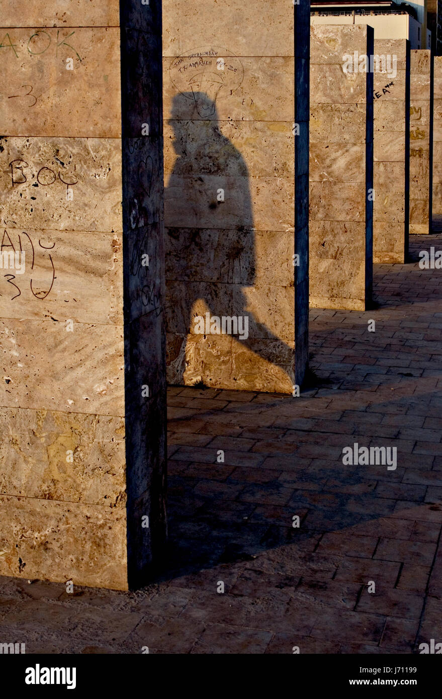 Passing by.The shadow of a man passing by Stock Photo - Alamy