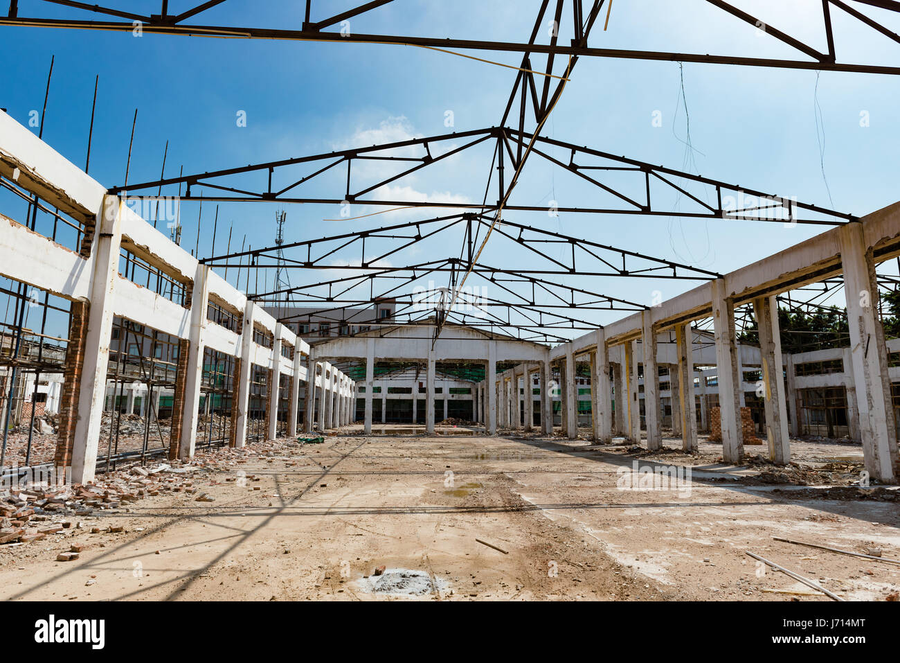 Demolition of an old building with roof only under blue sky Stock Photo ...
