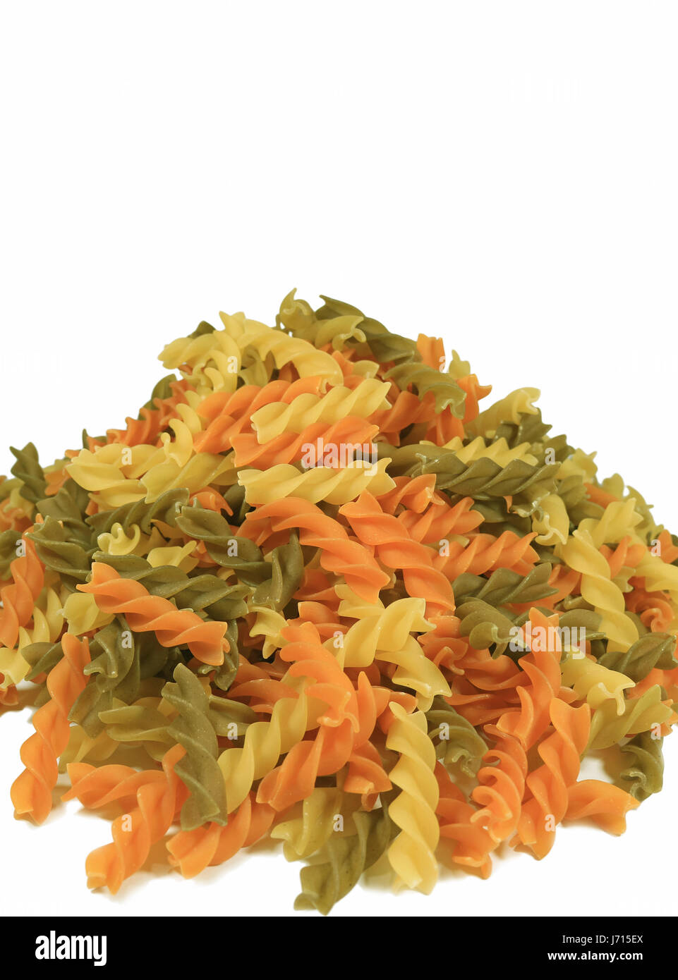 Uncooked Three-color Fusilli Pasta Piled-up on White Background ...