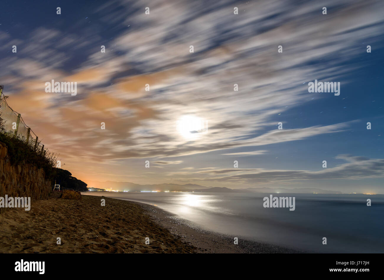 beach at night with full moon and cloudy sky, long exposure Stock Photo ...