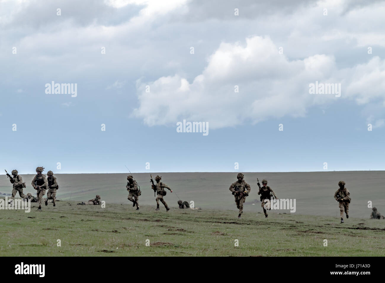 British soldiers run for a new position while being defended by a ...