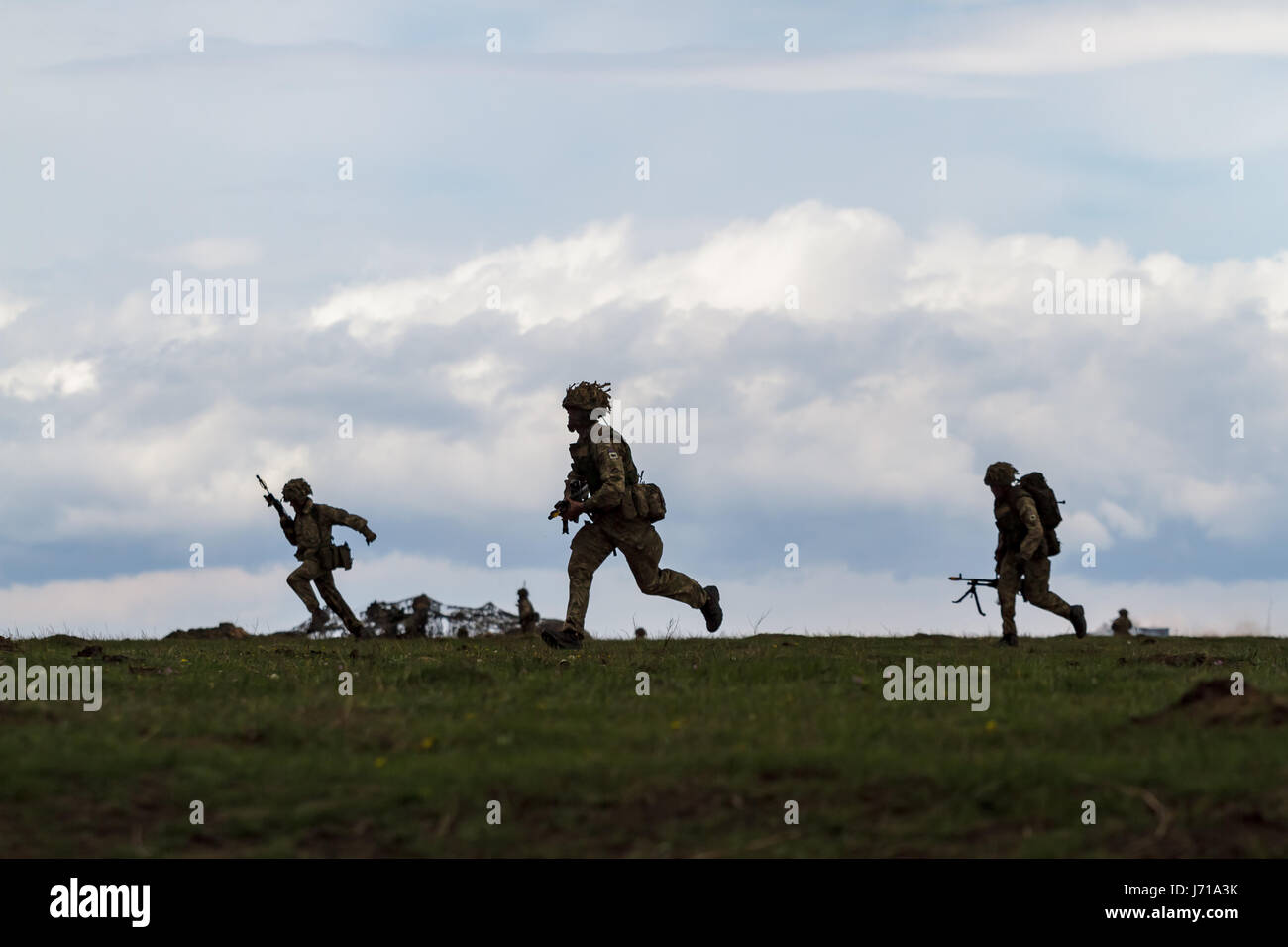 British soldiers run for a new position while being defended by a ...