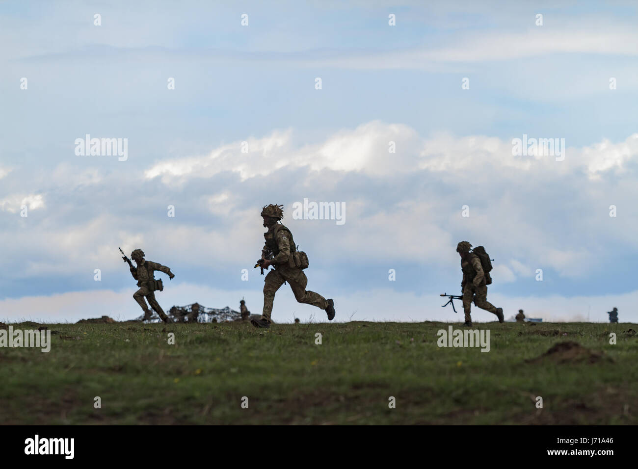 British soldiers run for a new position while being defended by a ...
