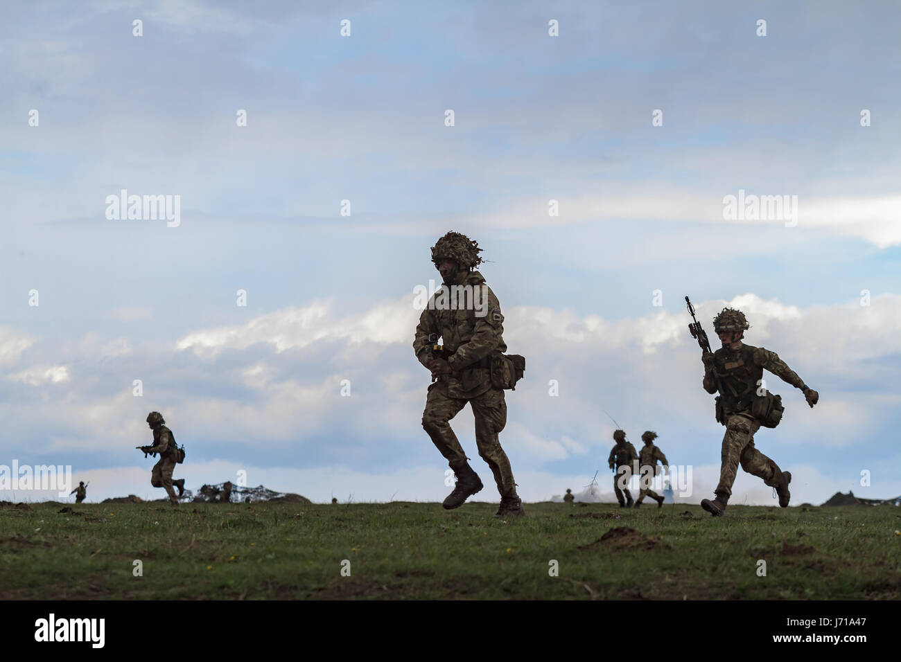 British soldiers run for a new position while being defended by a ...