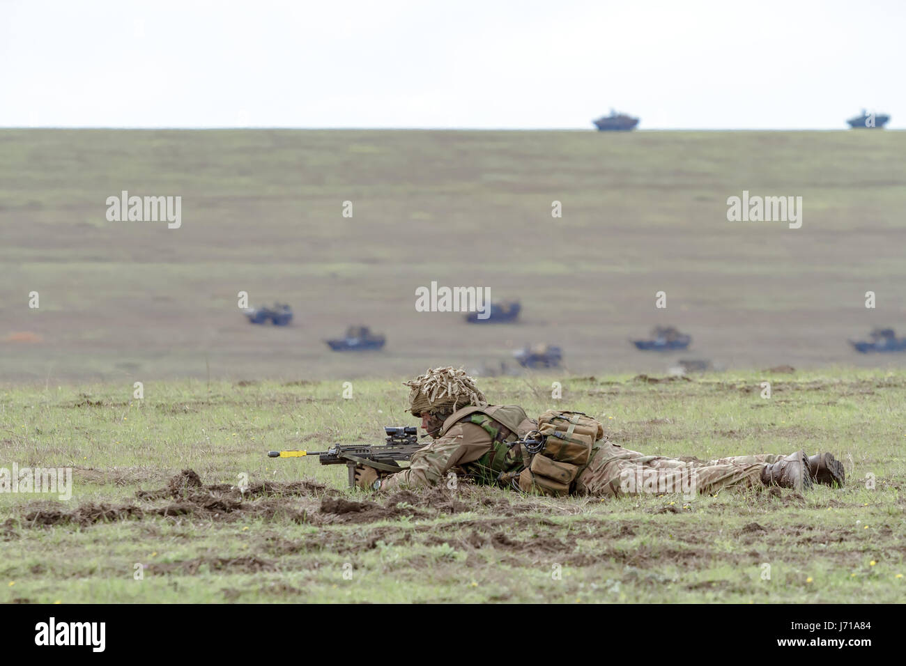 British soldiers run for a new position while being defended by a ...