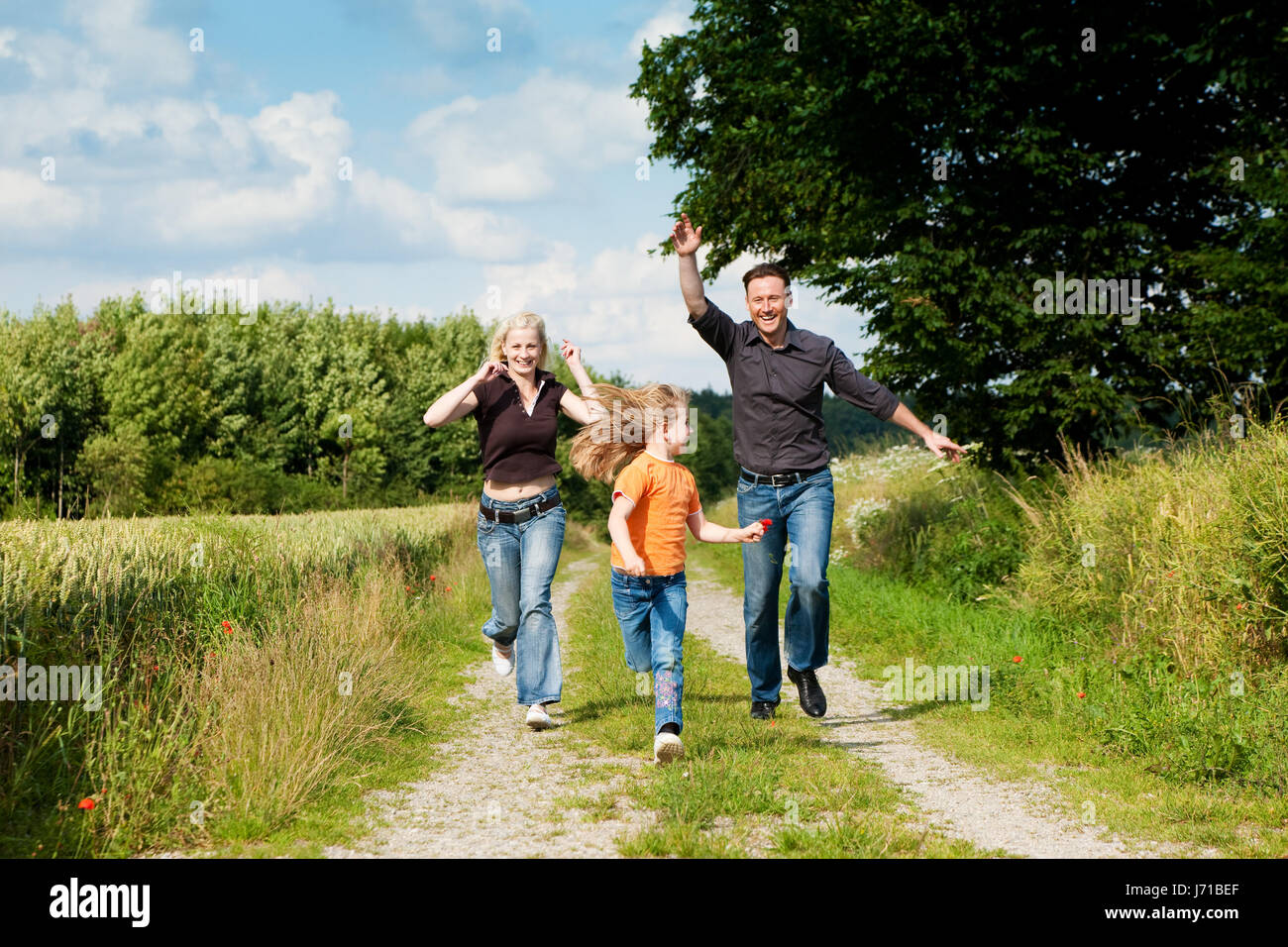 family strolling in action Stock Photo - Alamy