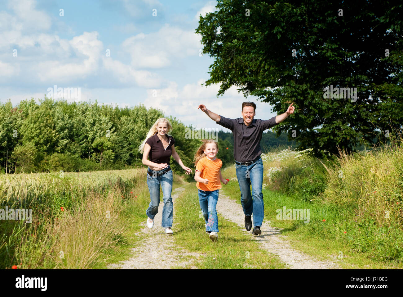 family taking a walk in action Stock Photo - Alamy