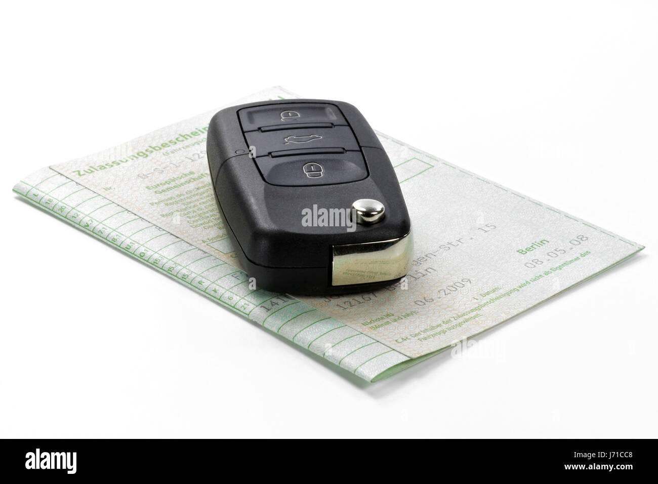 car key with German vehicle registration certificate isolated on white ...